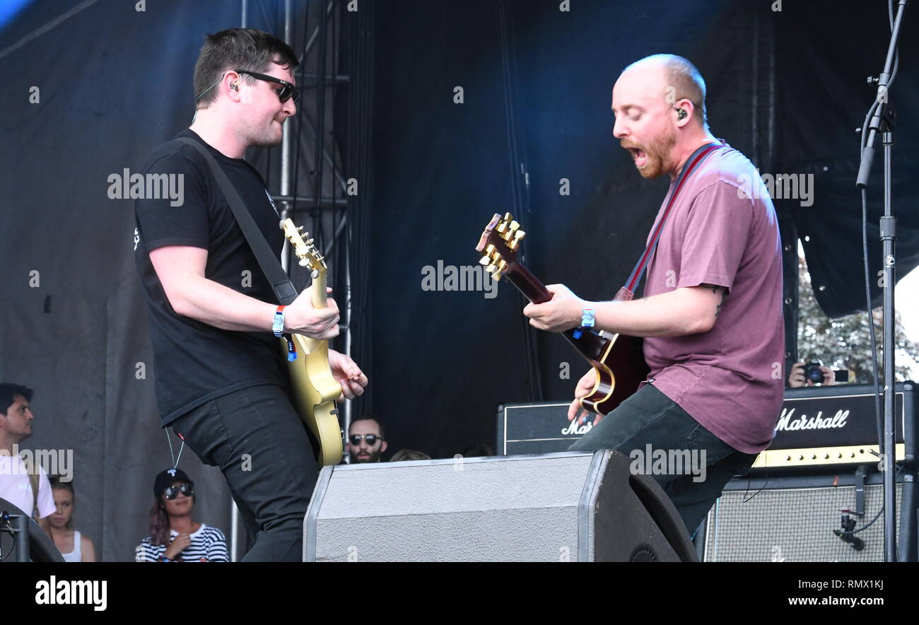 The Menzingers are shown performing on stage during a "live" concert ...