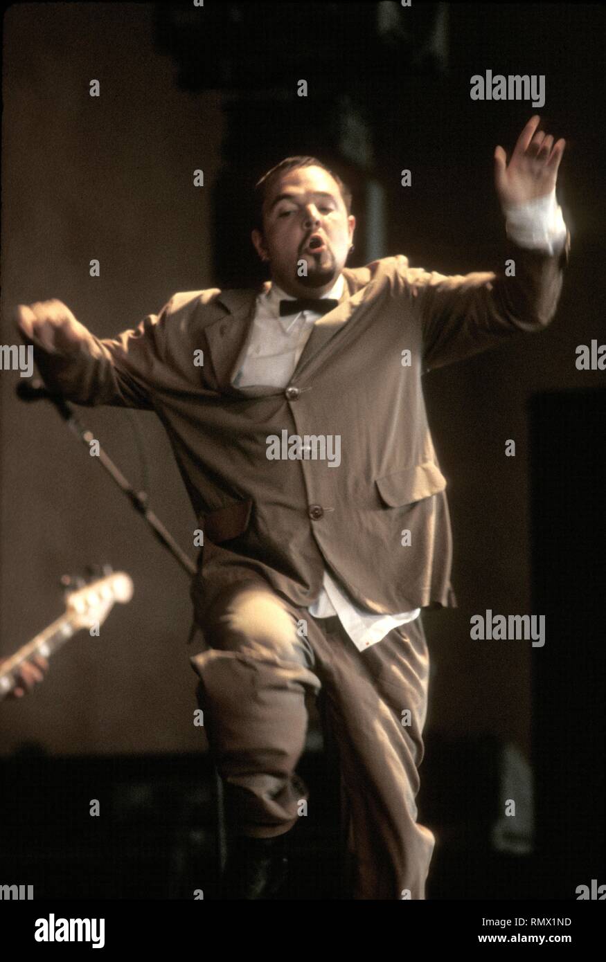 A band member of the Mighty Mighty Bosstones is shown performing on ...