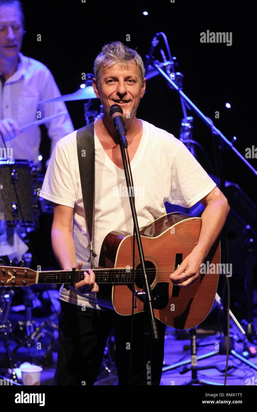 Singer Robbie Grey is shown performing on stage during a "live" concert ...