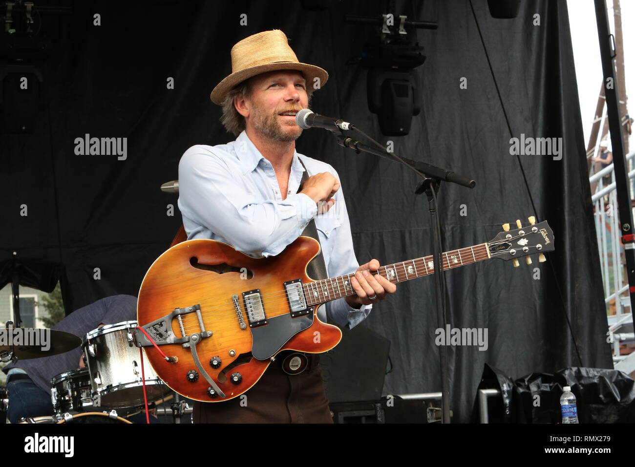 Musician Tim Bluhm is shown performing on stage during a "live" concert ...