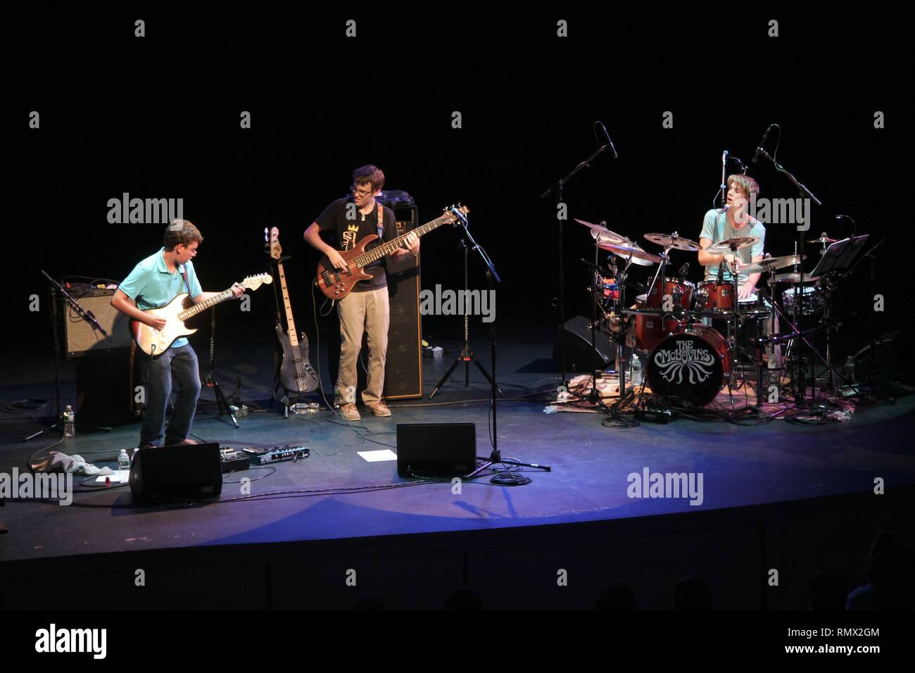 The McLovins are shown performing on stage during a "live" concert ...