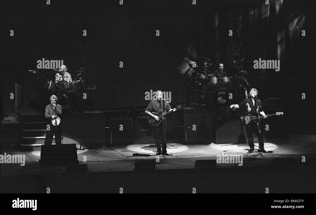 The Moody Blues are shown performing on stage during a "live" concert ...