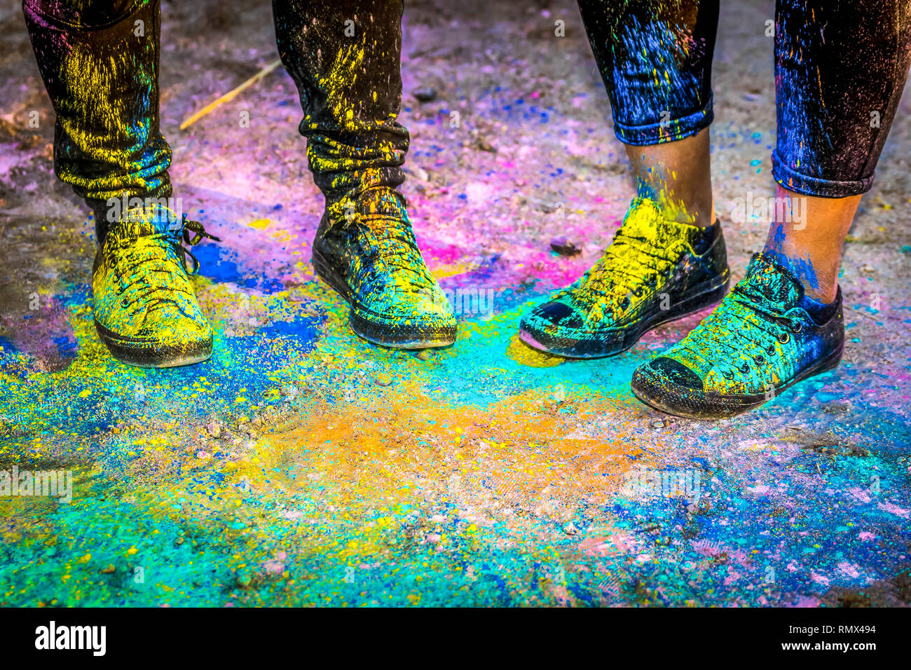 Black running shoes covered in colorful powder paint Stock Photo - Alamy