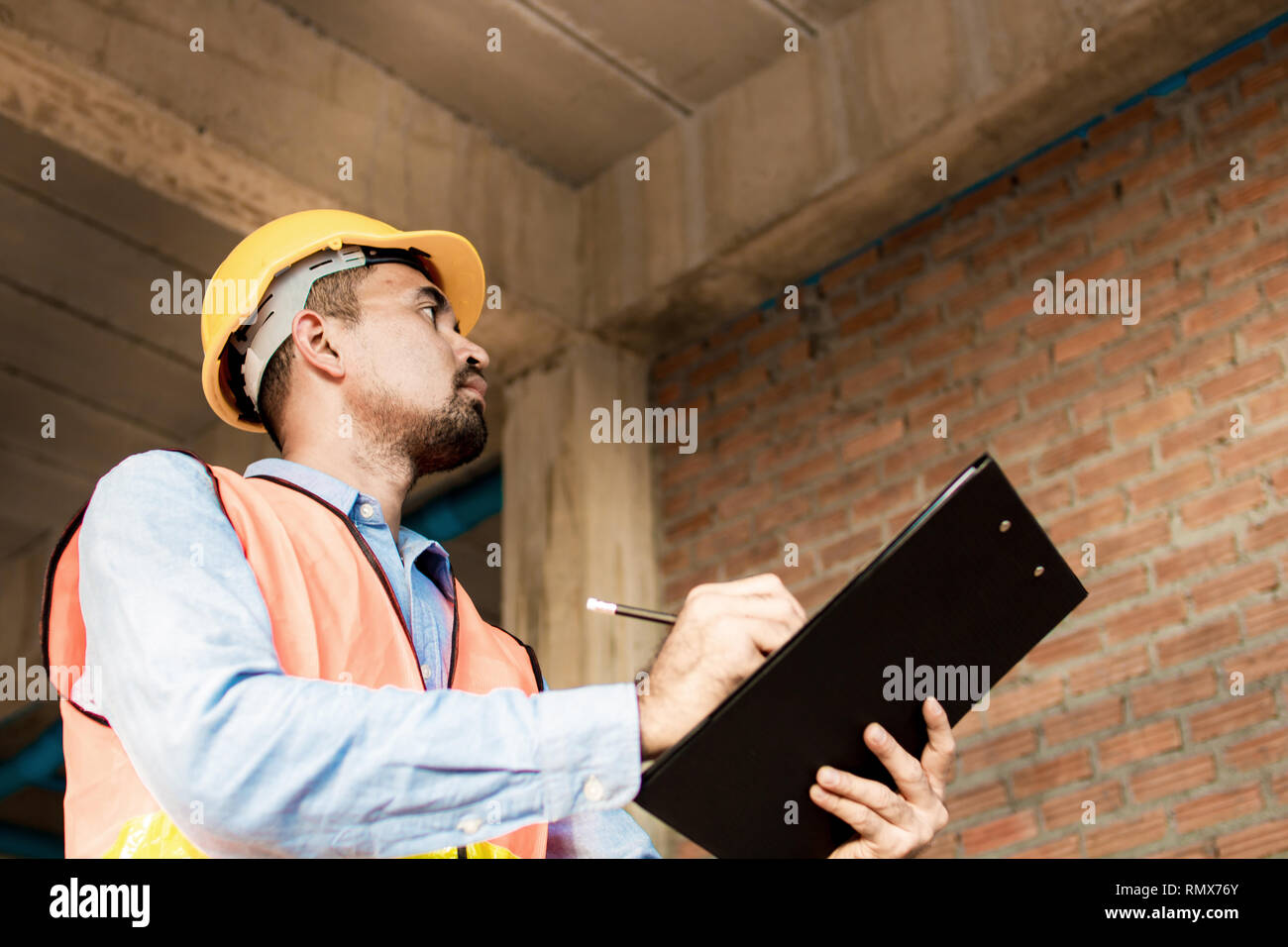 Engineer or inspector checking progressing work in construction site ...