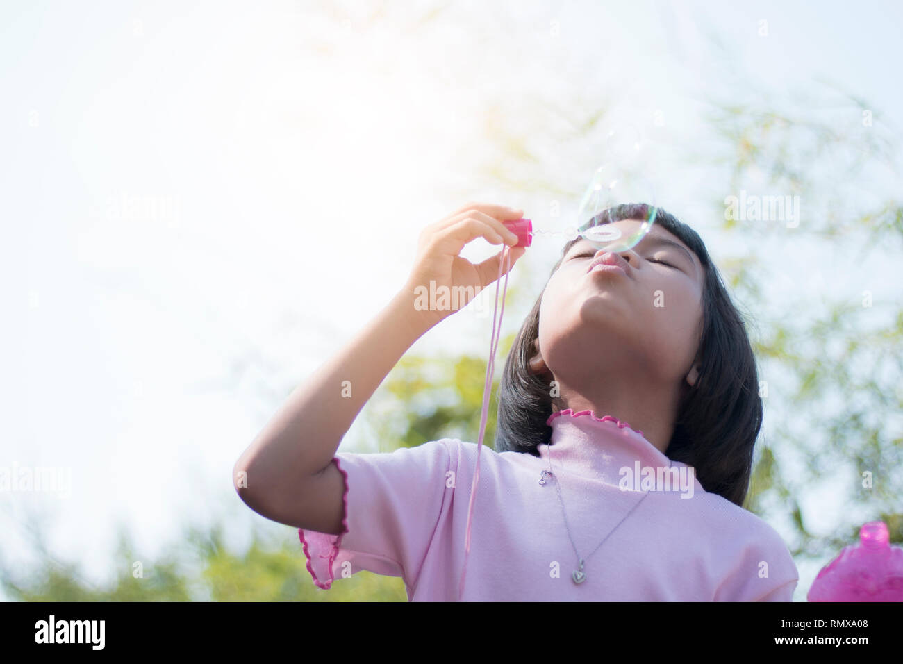 Asian kid blowing bubble hi-res stock photography and images - Alamy