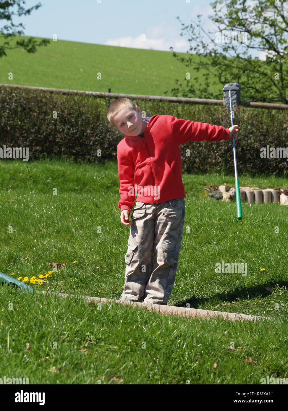 Little boy playing golf on vacation Stock Photo - Alamy