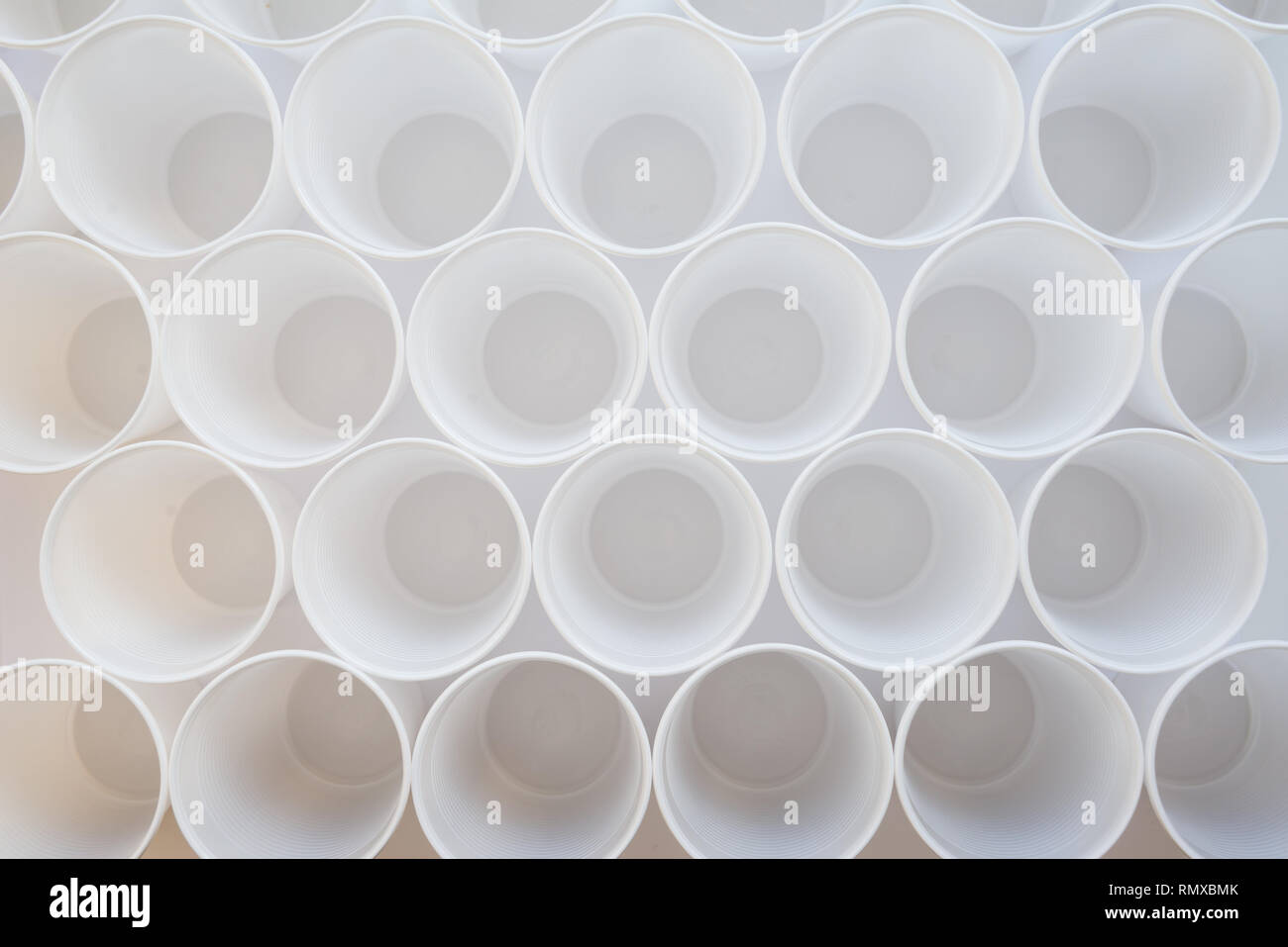 White single-use plastic cups top view as a background. Background ...