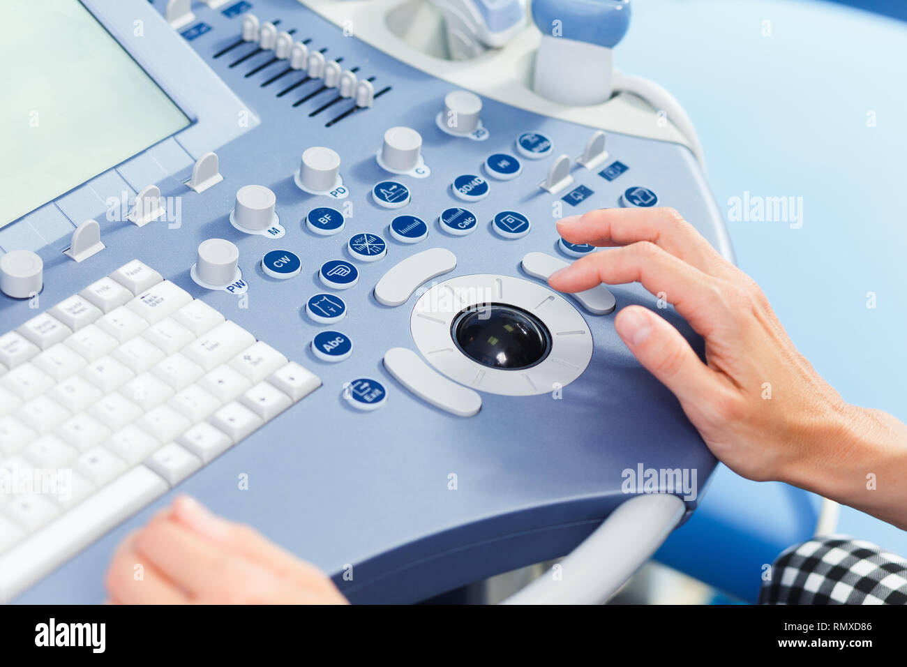 Hands of a doctor who uses the medical ultrasound diagnostic machine ...