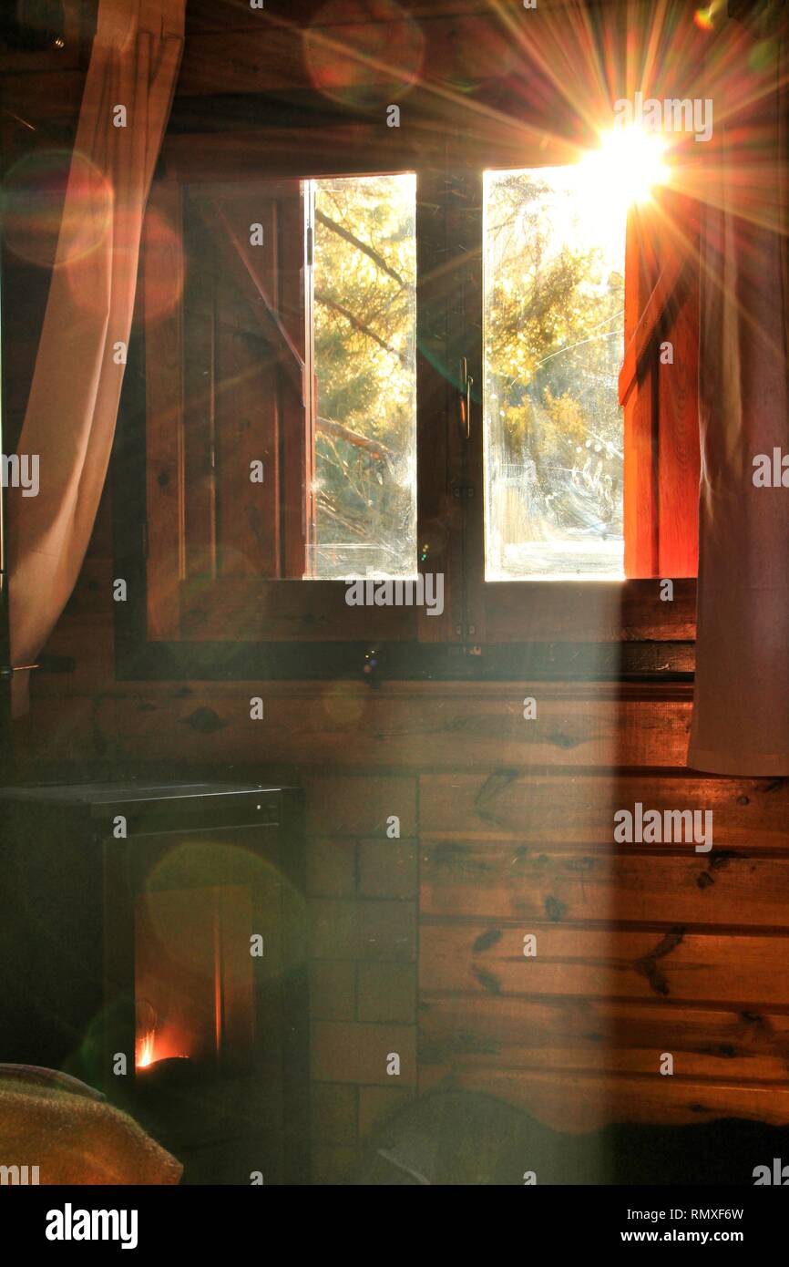 Morning sunlight entering through the window in log cabin Stock Photo ...