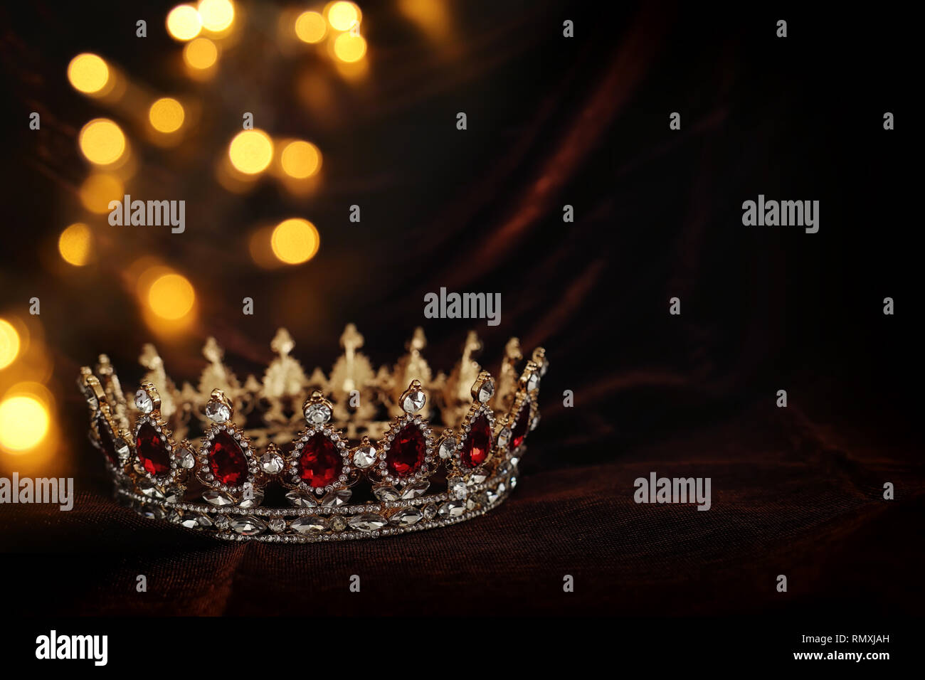 photo of gold crown over gothic dark silk background. Medieval period ...