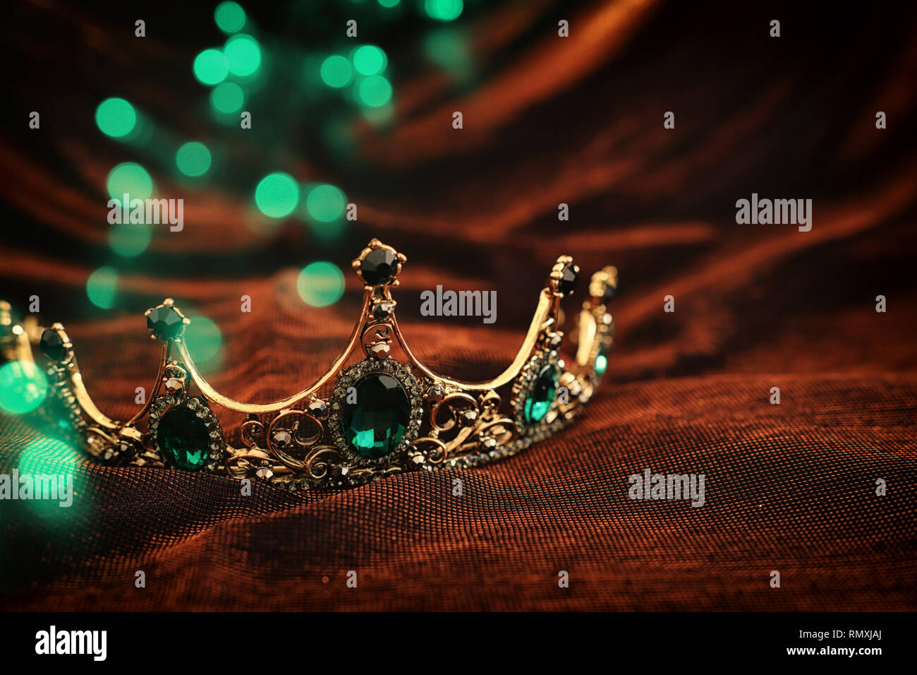 photo of gold crown over gothic dark silk background. Medieval period ...