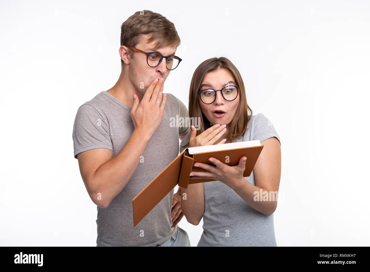Nerds, study, people concept - a couple of people look at the book and ...