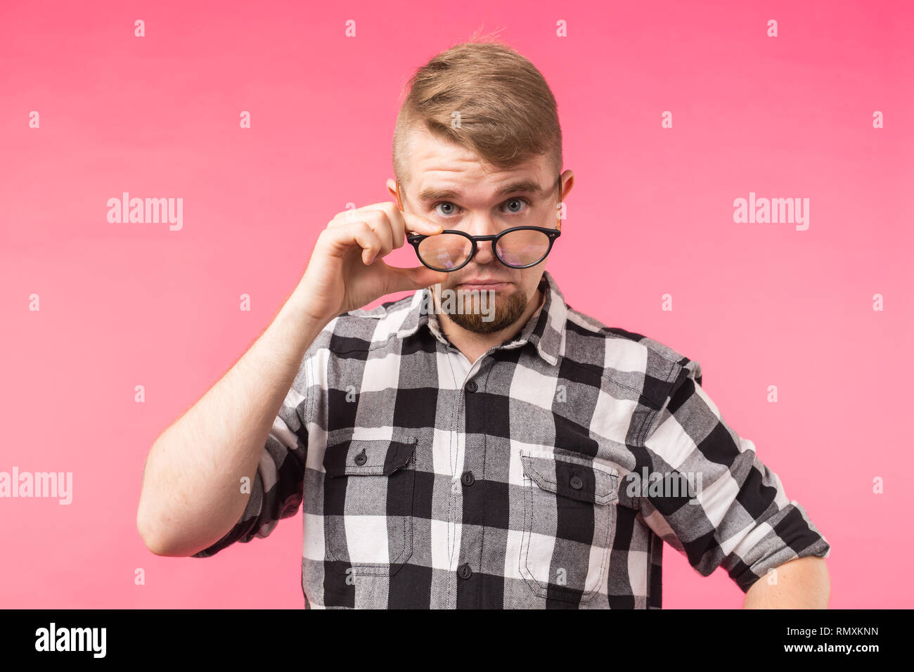 Nerd, geek and education concept - Serious student man on pink ...