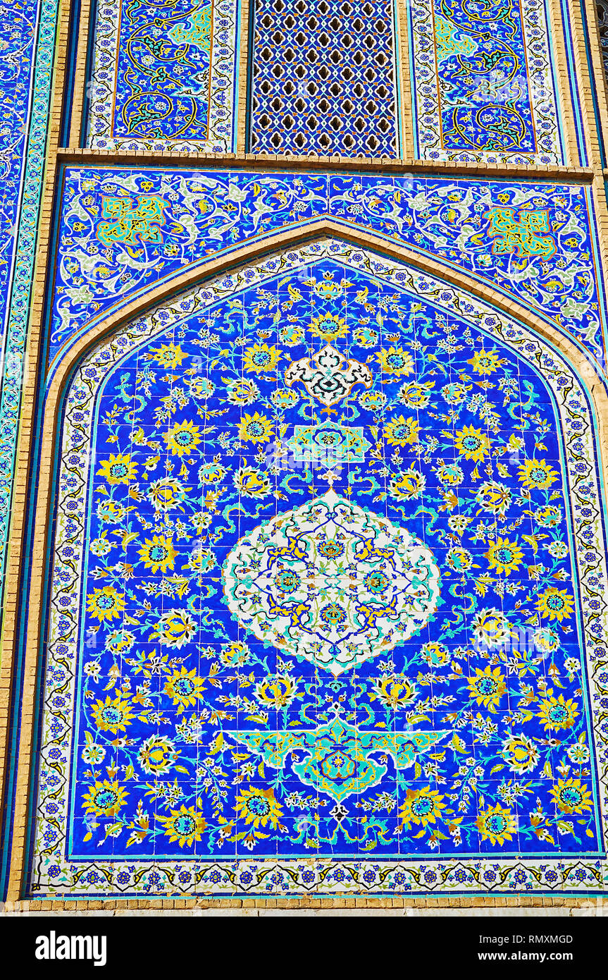 The bright blue decorative panel with fine floral pattern on facade ...