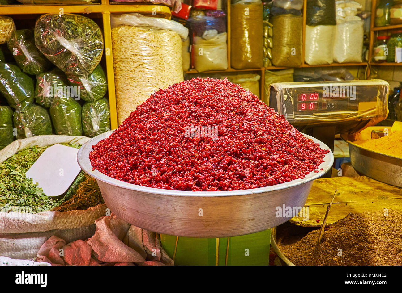 The bowl with large heap of dried barberry (berberis) in spice shop of ...