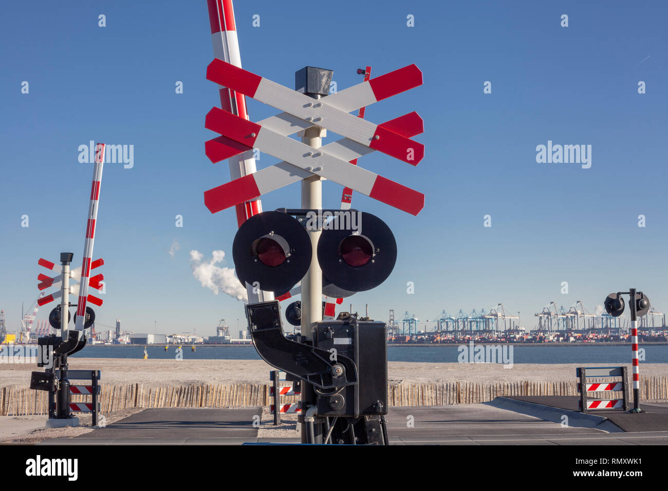 Port of rotterdam. Road signs at the railway crossing with a barrier ...
