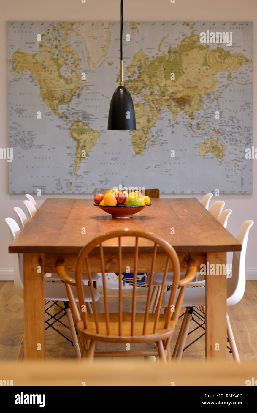Dining room table with wall map Stock Photo - Alamy