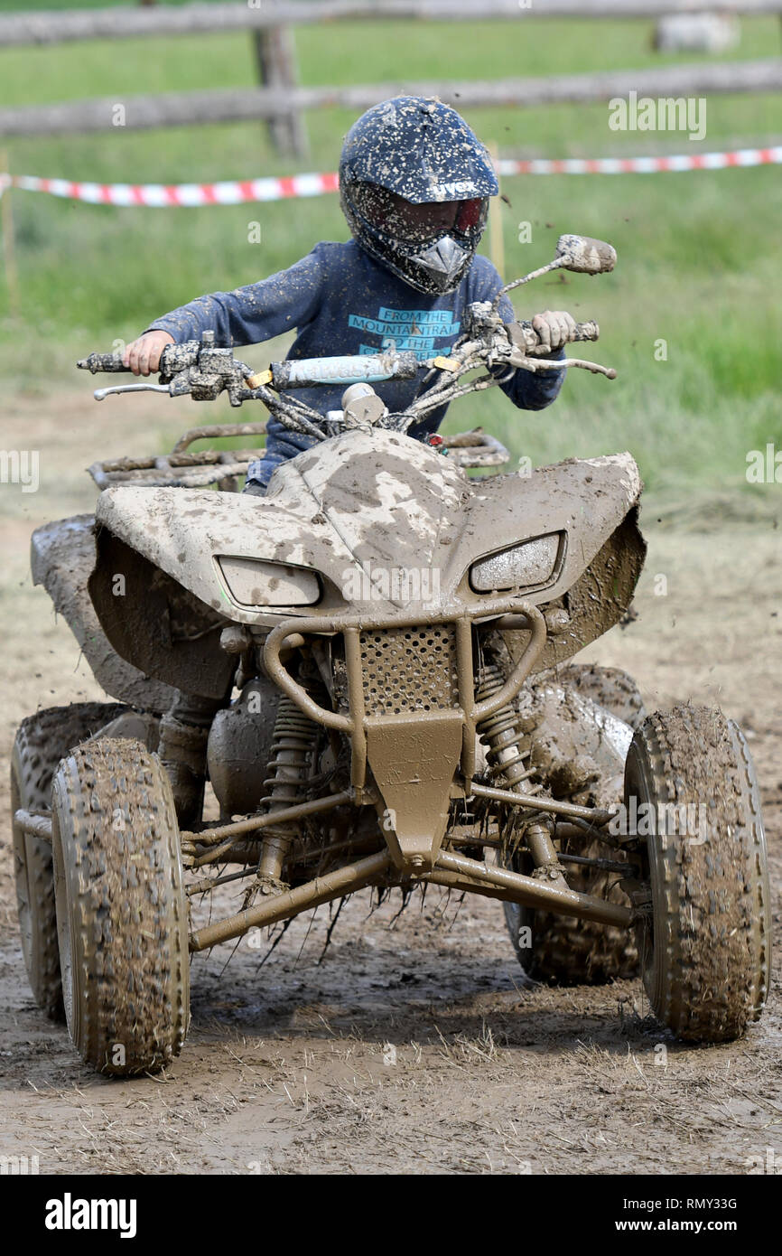 A young boy riding a quad/ATV offroad Stock Photo - Alamy