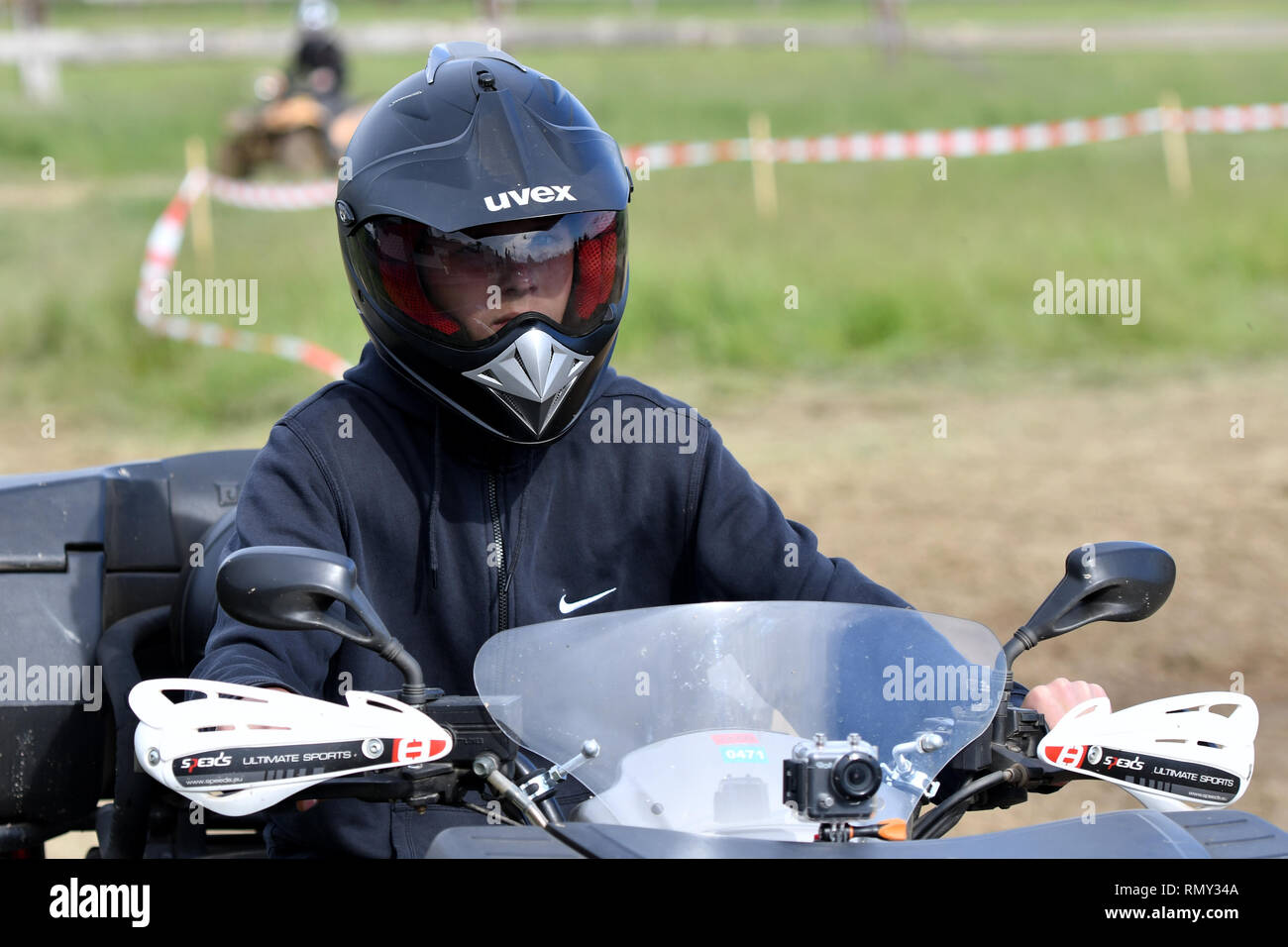 A young boy riding a quad/ATV offroad Stock Photo - Alamy
