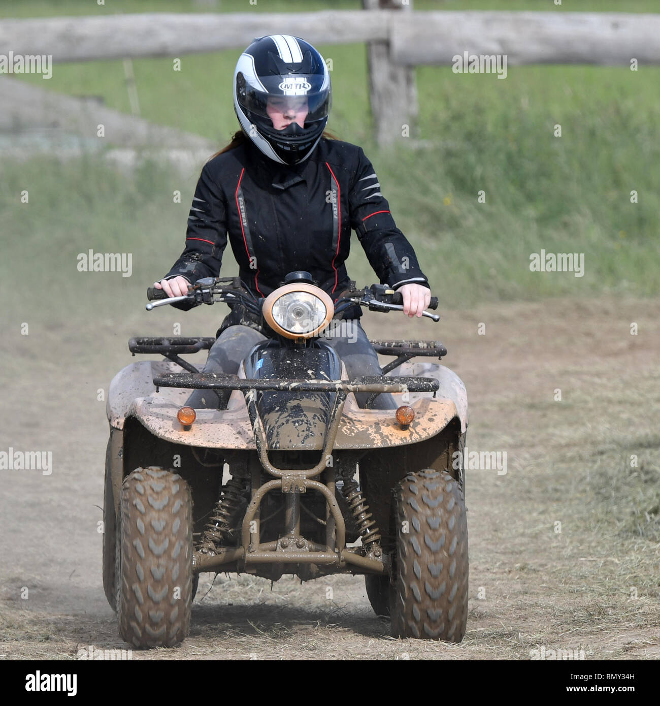 A young female riding a quad/ATV offroad Stock Photo - Alamy