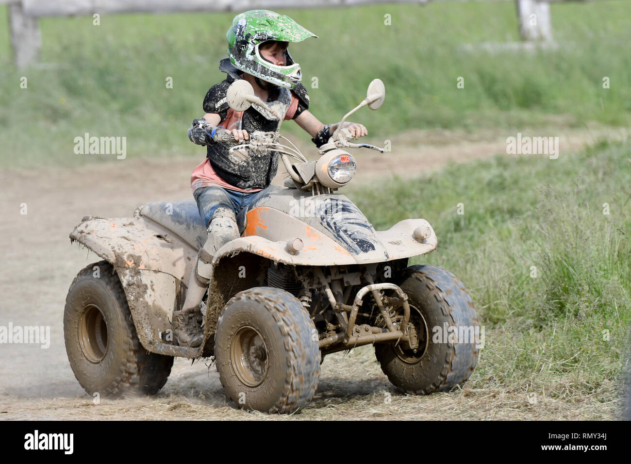 A young boy riding a quad/ATV offroad Stock Photo - Alamy
