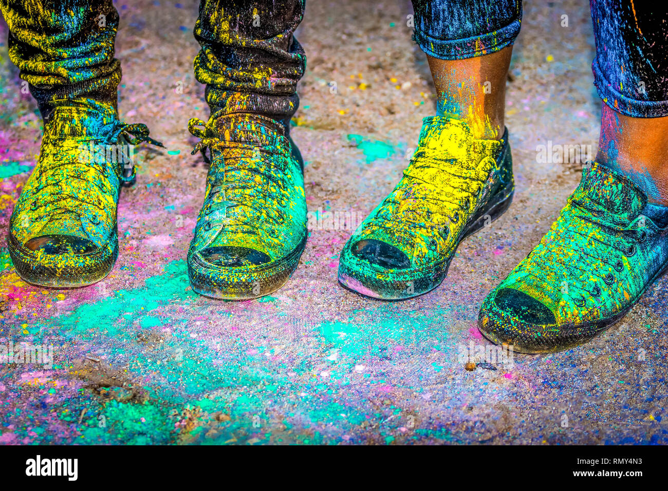 Black running shoes covered in colorful powder paint Stock Photo - Alamy