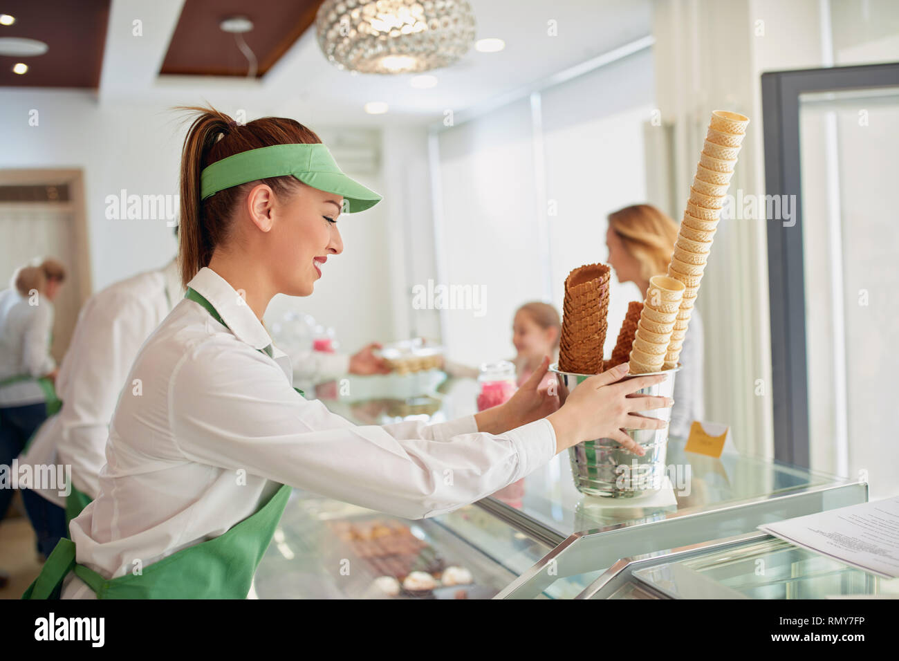 Young pretty woman at work in pastry shop Stock Photo - Alamy