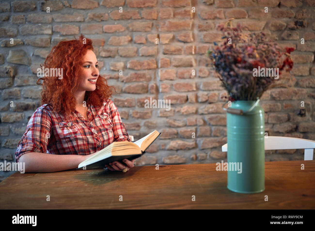 Redhead girl read book inside Stock Photo - Alamy