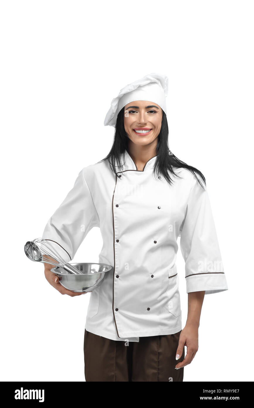 Young smiling confectioner posing at camera in professional uniform ...