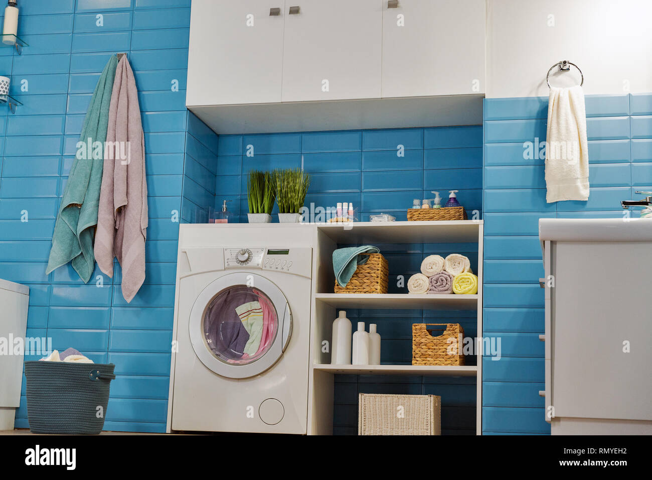 modern bathroom with white washing machine and blue tile Stock Photo ...