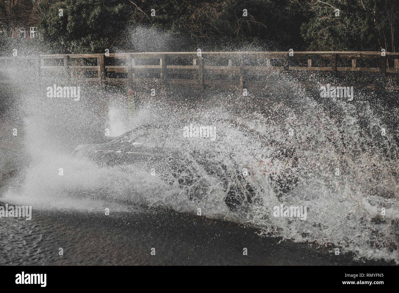 Cars splashing up water as they go through a ford Rufford Stock Photo ...
