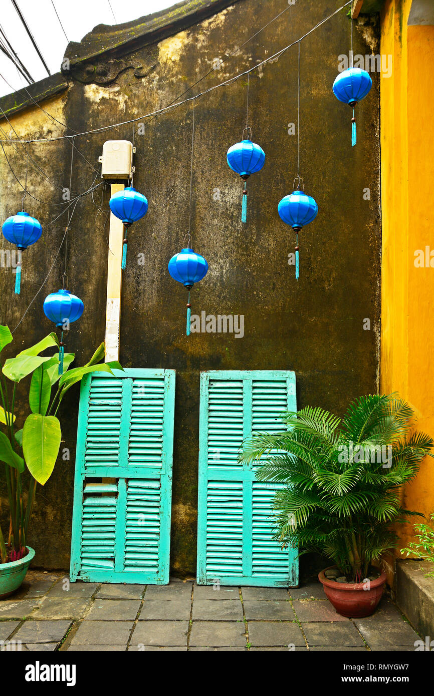 Two window shutters randomly standing against a wall in the historic ...