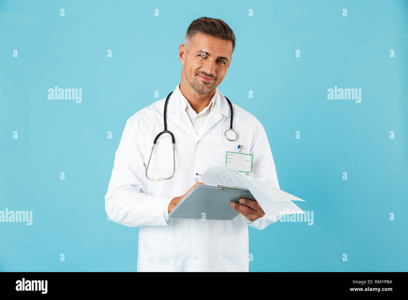 Portrait of cheerful medical doctor with stethoscope holding health ...