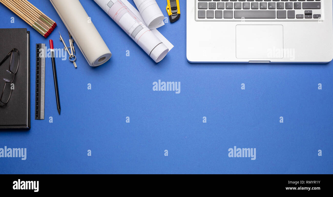 Architect engineer construction site office desk. Project blueprints ...