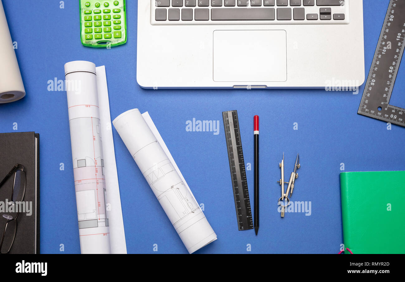 Architect engineer construction site office desk. Project blueprints ...