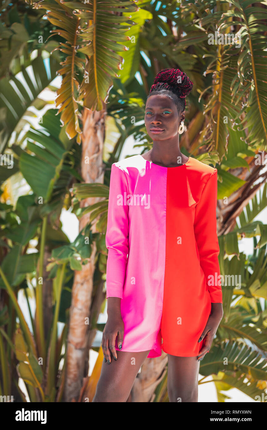 Attractive black woman wearing coral fringed dress walks the runway ...