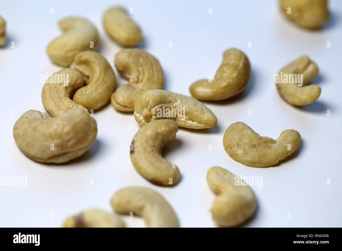 Natural, organic cashew nuts in a closeup photo. Photographed on top of ...