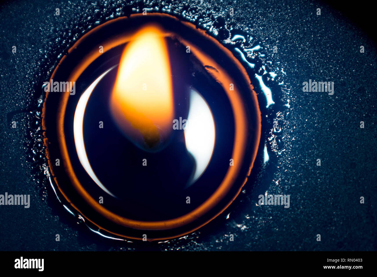 Close up, top view of a lighted blue candle background Stock Photo - Alamy