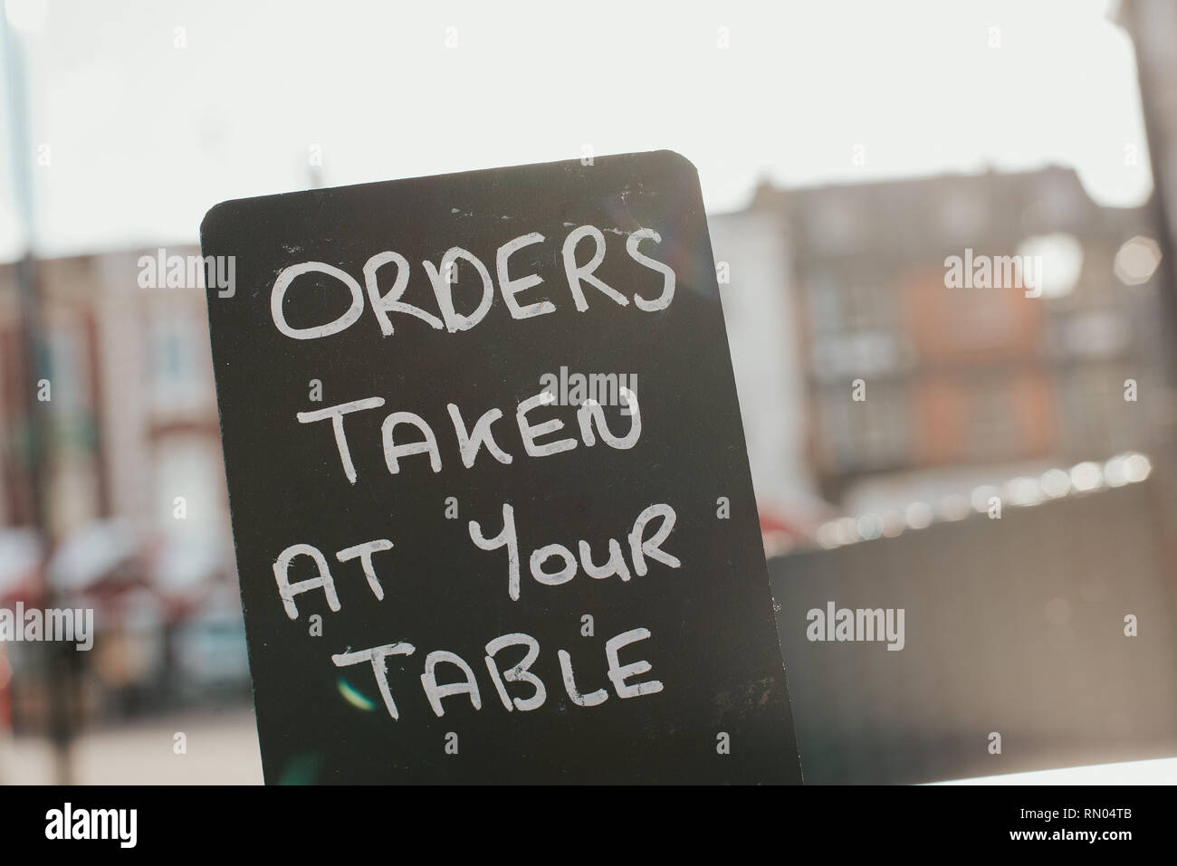 Orders taken at your table cafe sign Stock Photo - Alamy