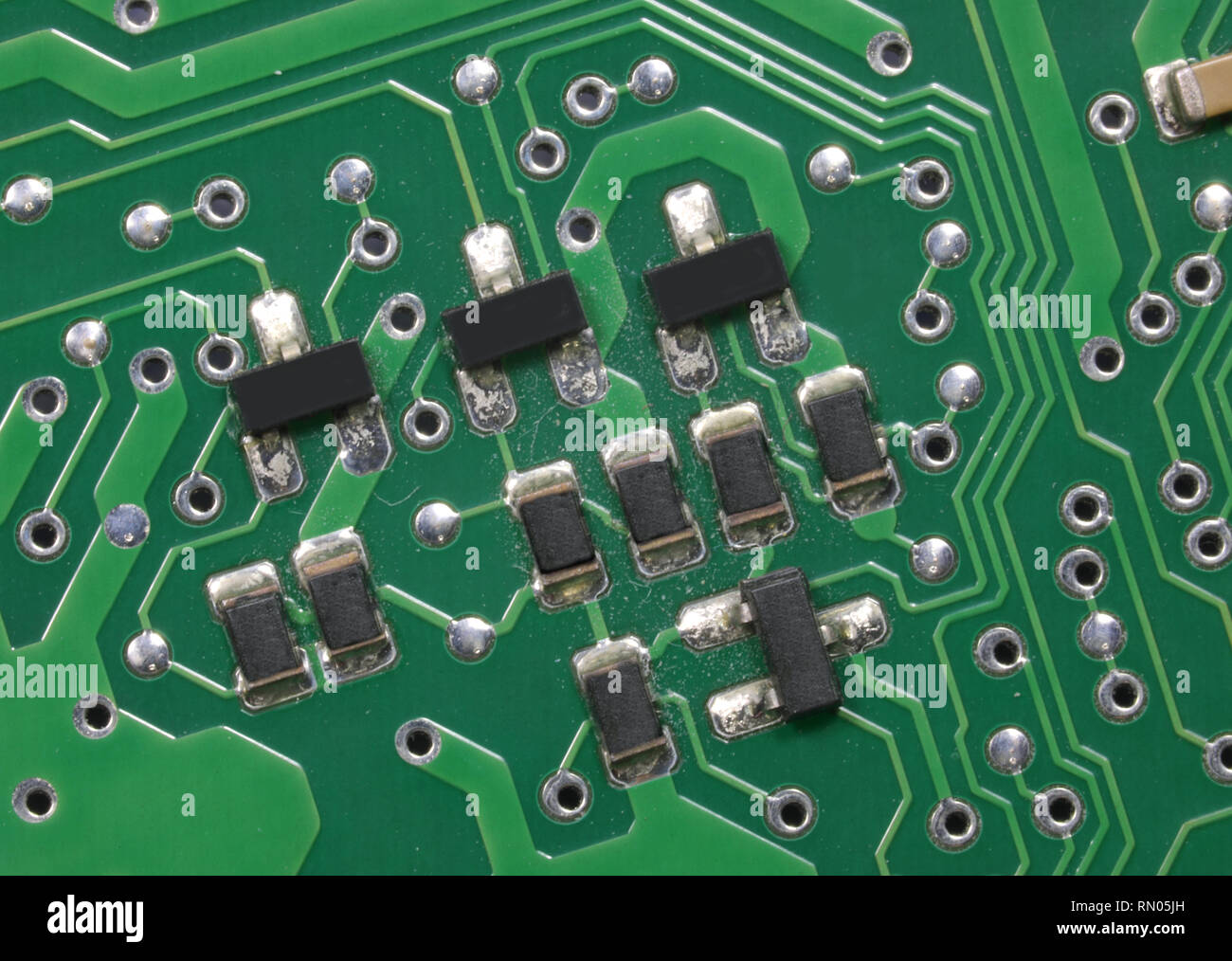 many mini transistors and diodes of an electronic board photographed ...