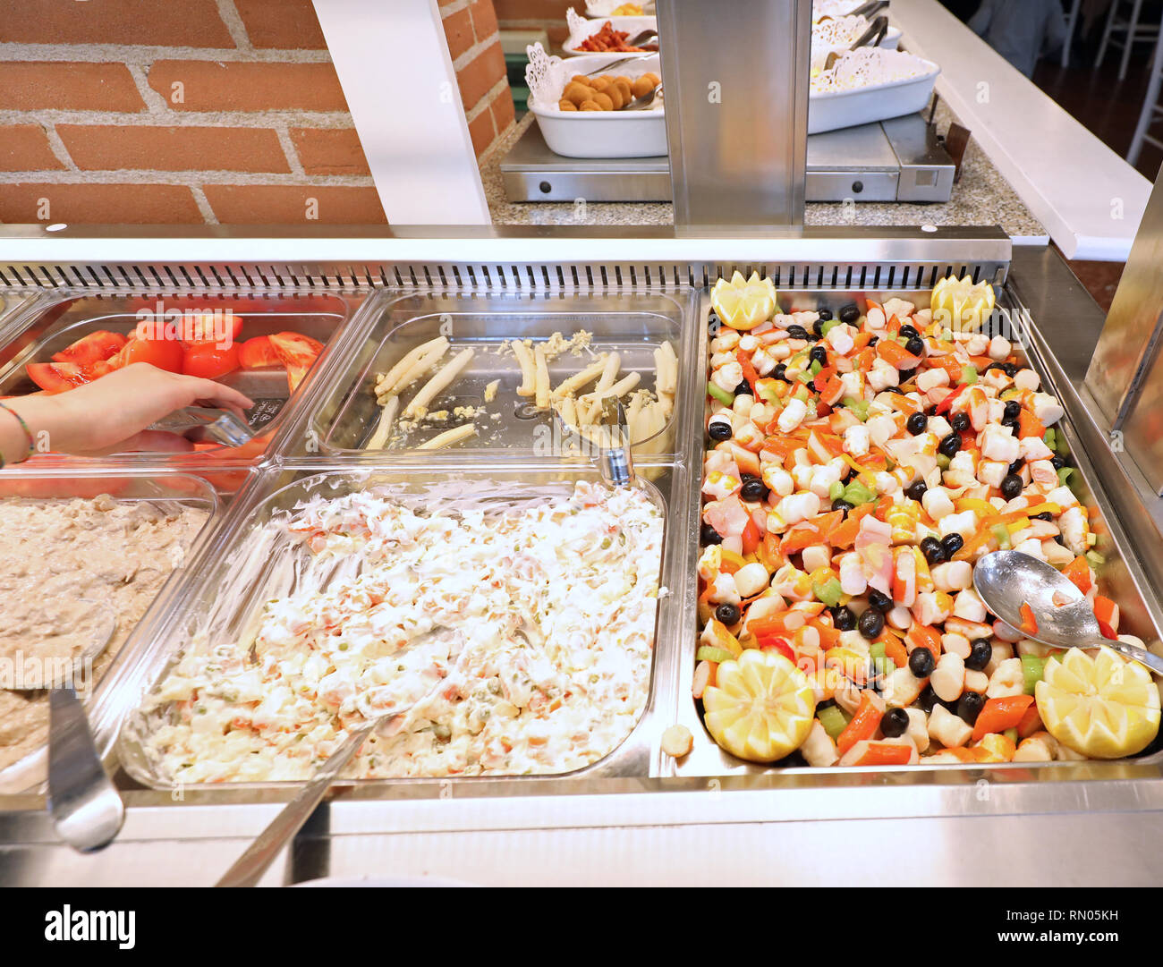 Inside a restaurant with many raw and cooked foods Stock Photo - Alamy