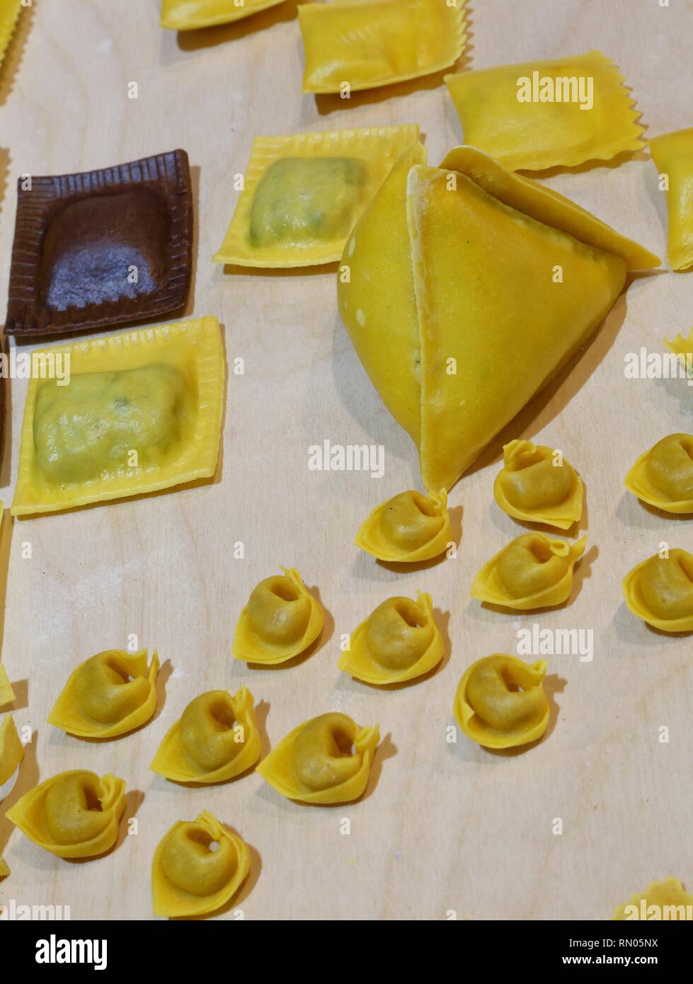 fresh pasta made with flour and eggs of various sizes for sale in ...