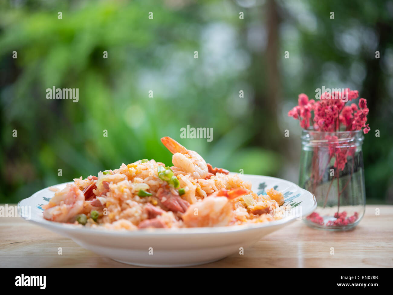 Delicious Thai fried rice with shrimp on wooden table with beauitful ...