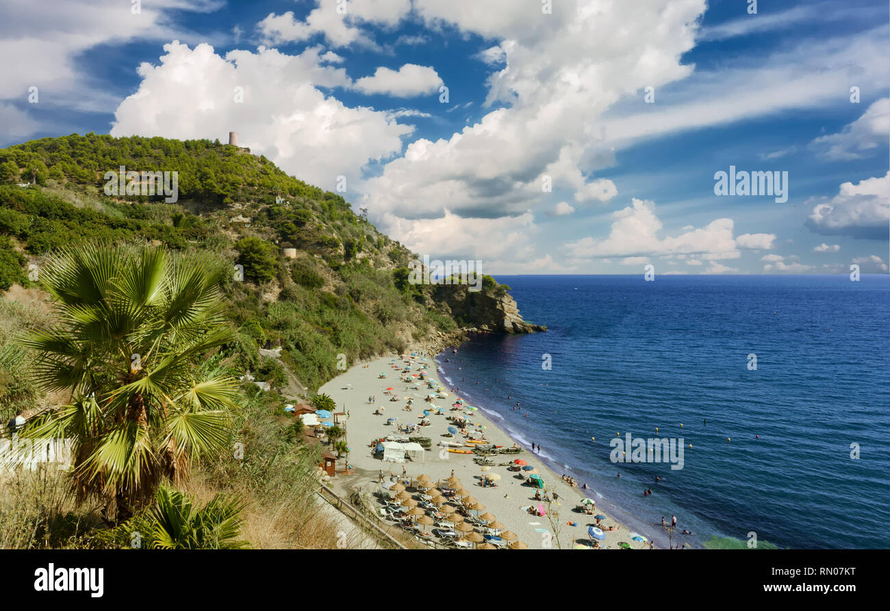 Picture of the Playa De Maro (Maro Beach) with a big sky with clouds ...