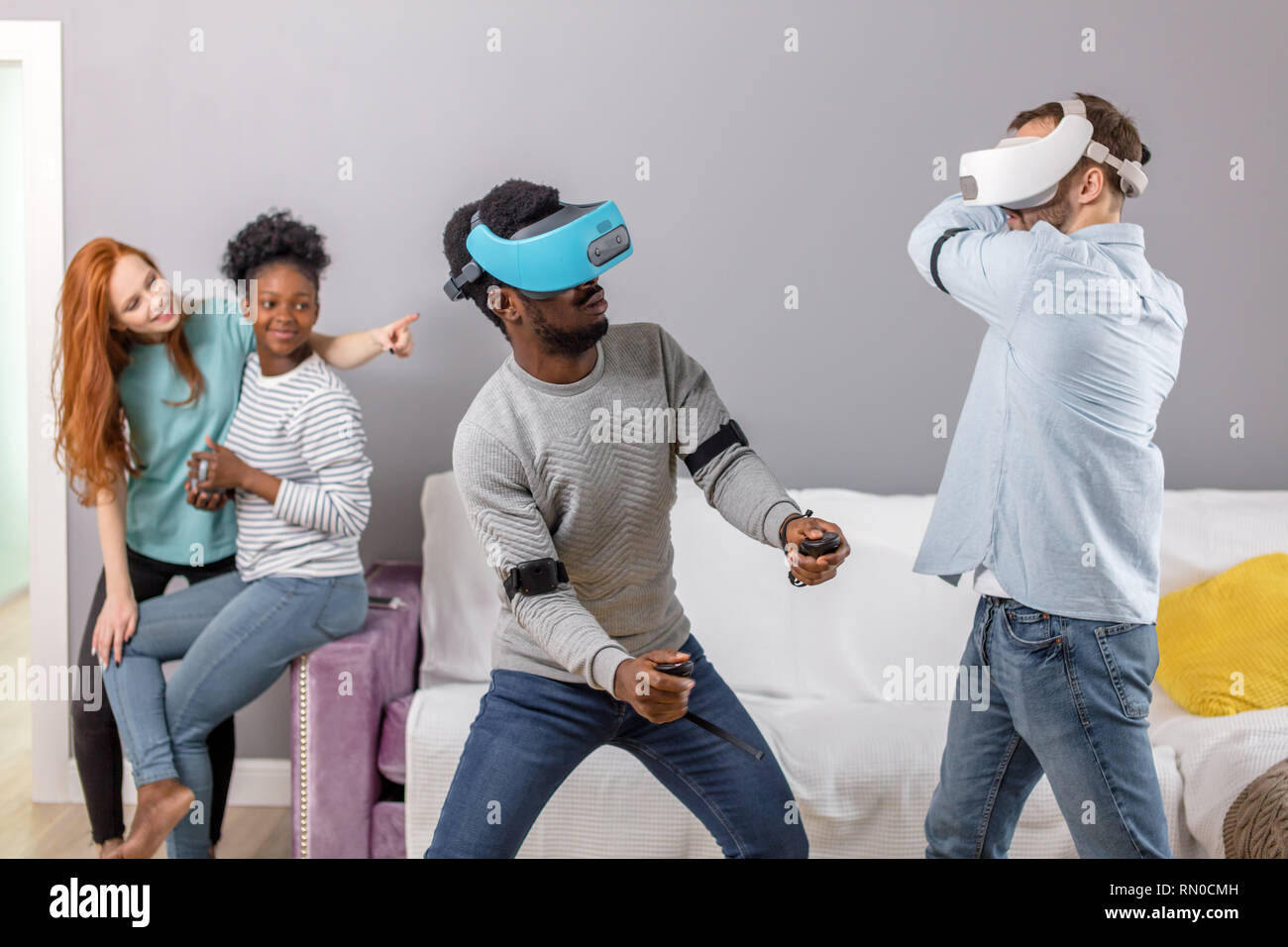 Multiethnic diverse friends enjoying VR technology, two guys wearing vr ...
