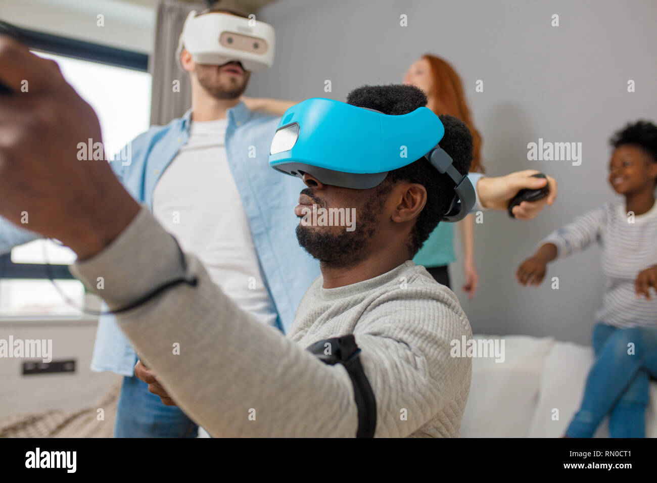 Group of multiracial male amd female students playing virtual game ...
