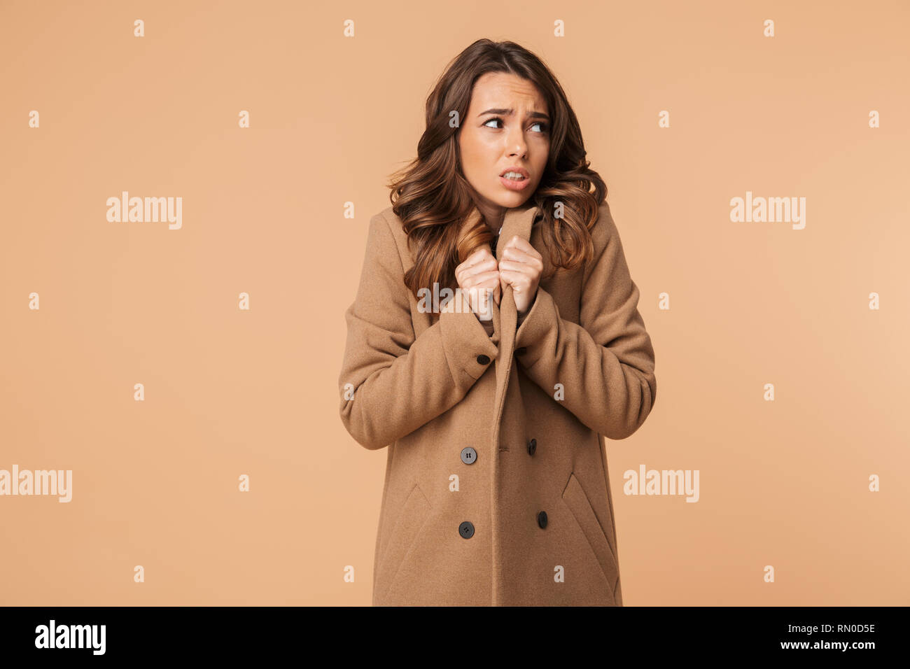 Image of a beautiful frozen emotional woman posing isolated dressed in ...