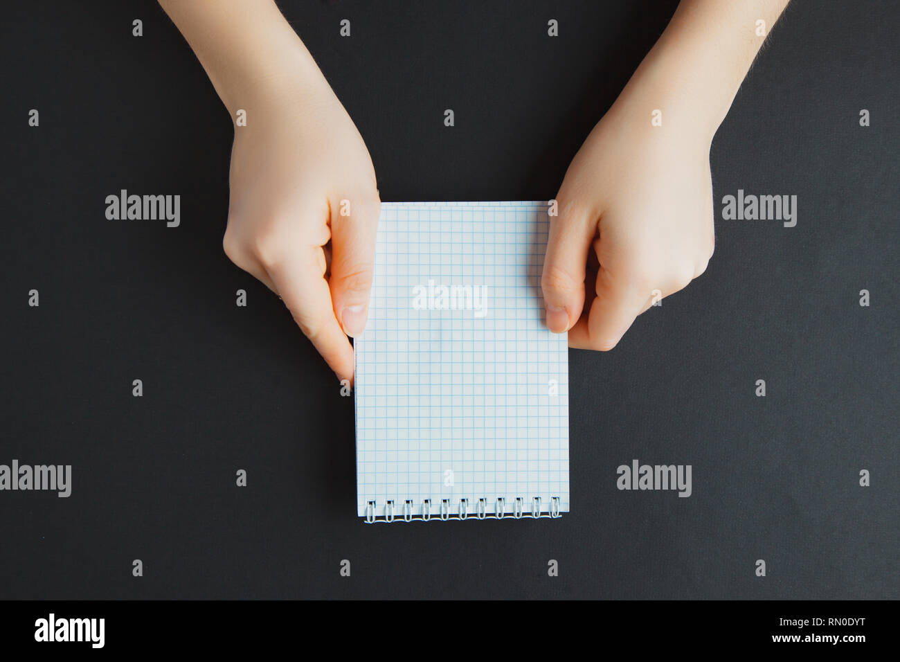 A portrait of hand, with blank notes over blackboard background Stock ...