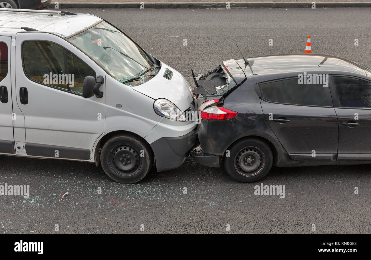 Auto accident involving two cars on a city street Stock Photo - Alamy