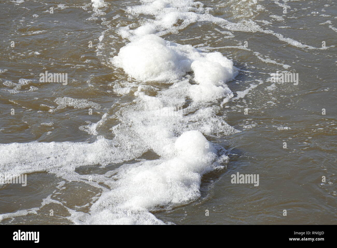Foaming water in a river Stock Photo - Alamy